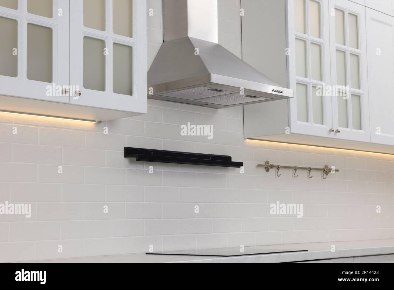 Modern range hood and furniture in kitchen Stock Photo - Alamy