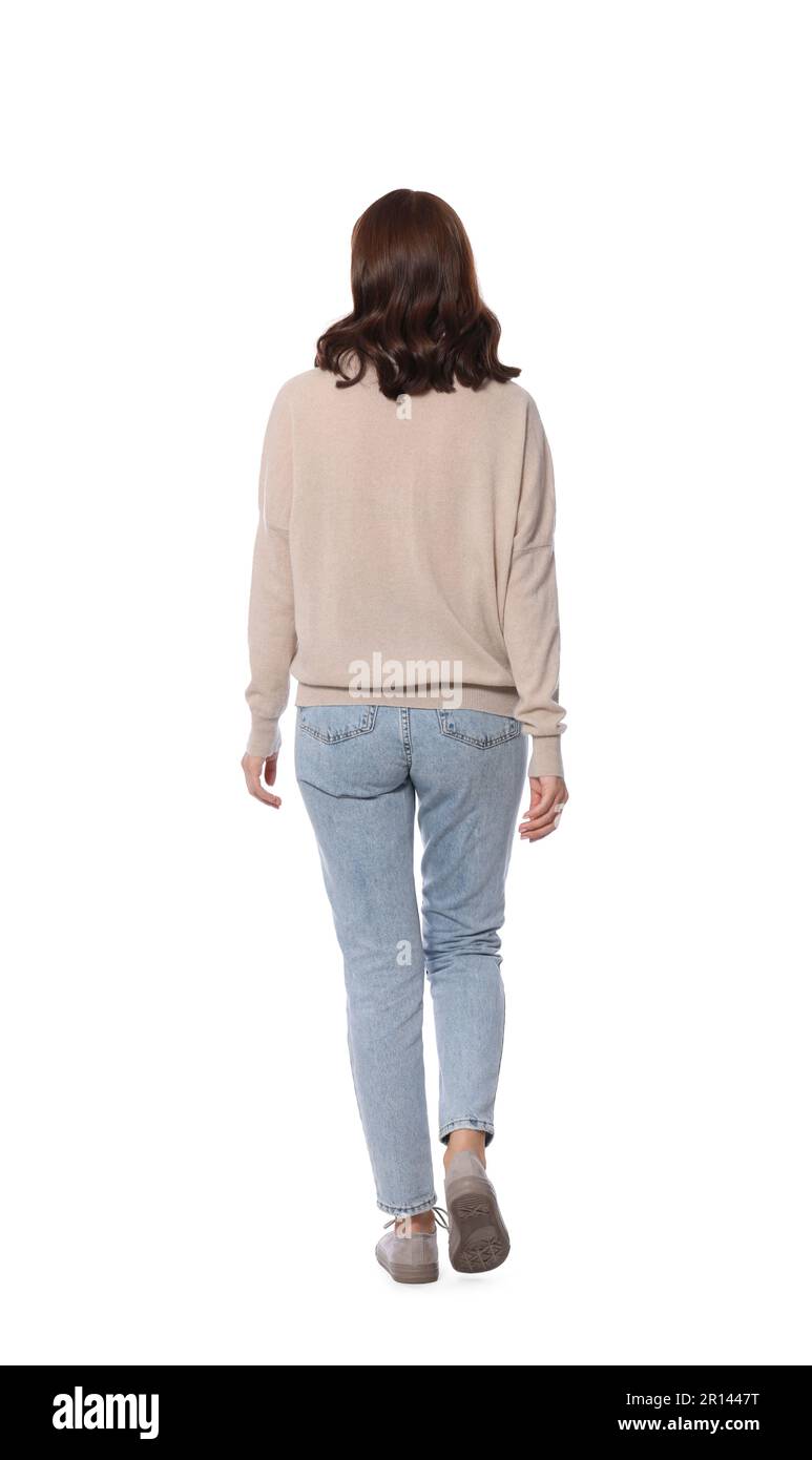 Woman in casual outfit walking on white background, back view Stock ...