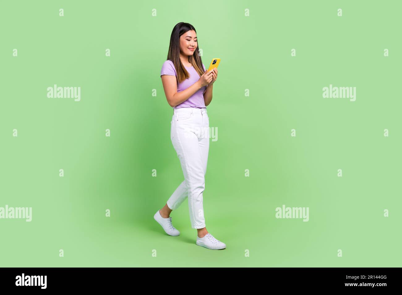 Full body size photo of young charming attractive chinese girl with smartphone walk write blog ...