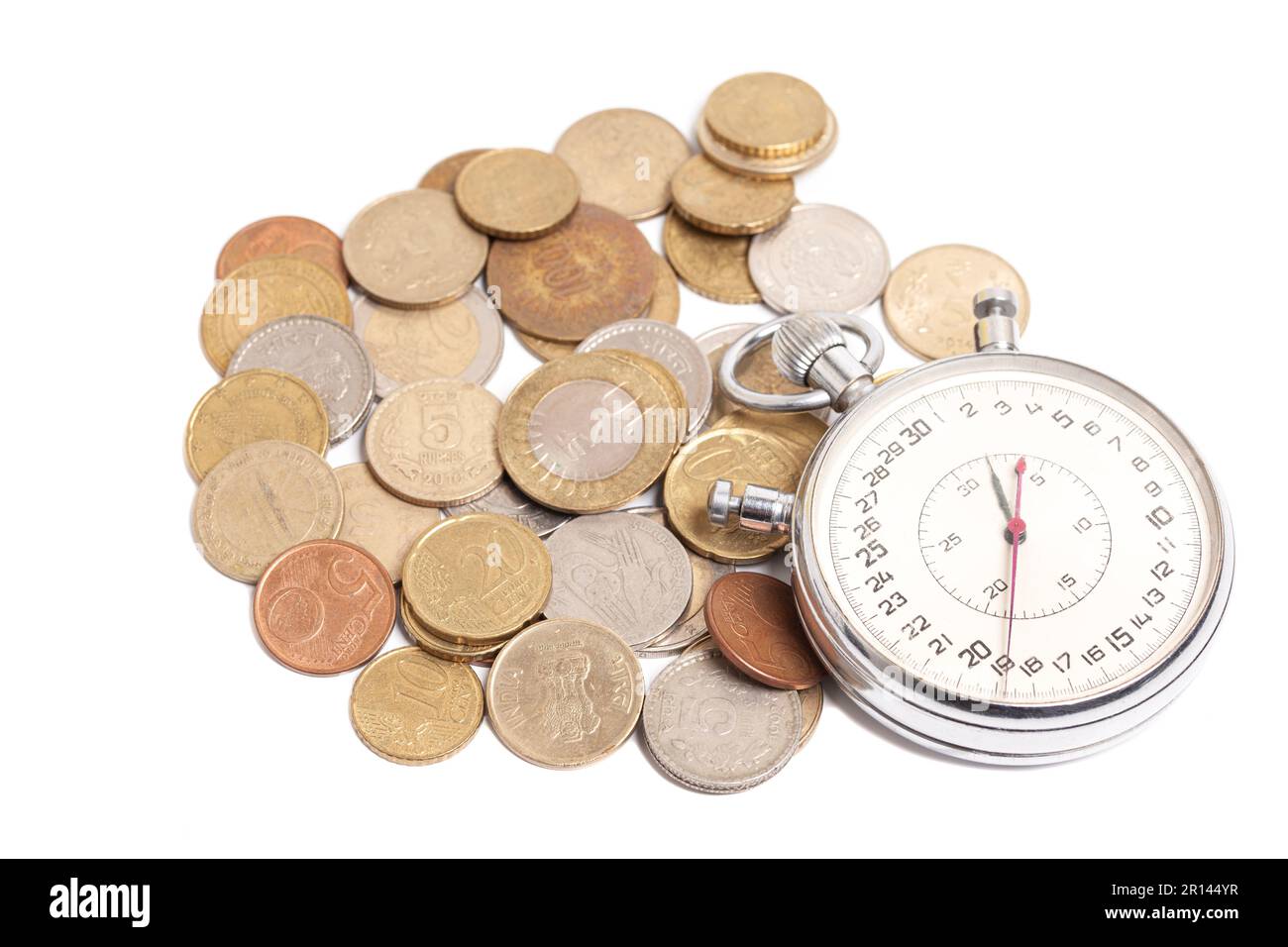 Time is money. Stopwatch and pile of coins Stock Photo - Alamy
