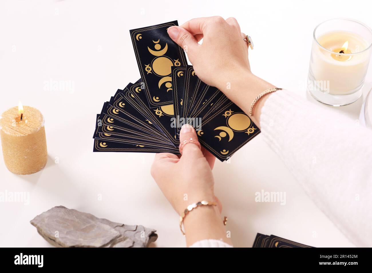 Soothsayer pulling one tarot card at table, closeup. Future telling ...