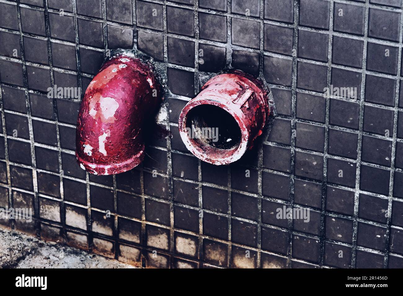 Aclose-up of aged metal pipes coated in a layer of red paint Stock ...