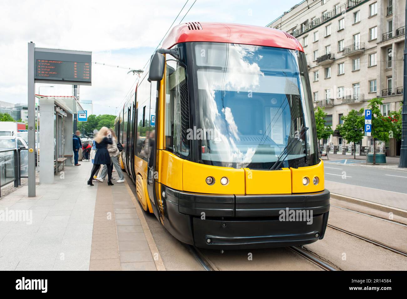 Beautiful tram on railroad near building outdoors Stock Photo - Alamy