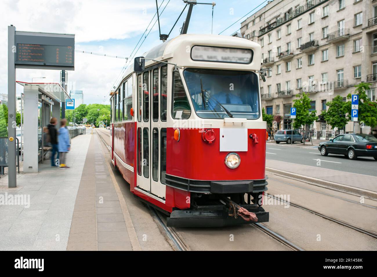 Beautiful tram on railroad near building outdoors Stock Photo - Alamy