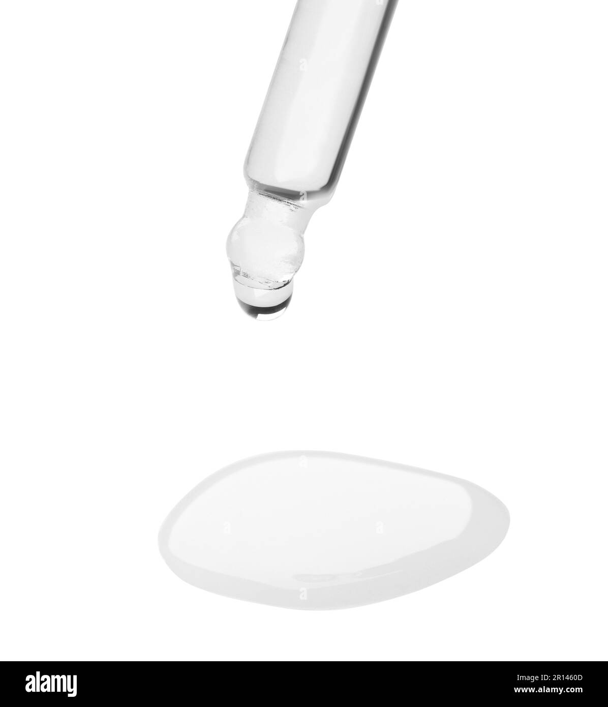 Dripping face serum from pipette on white background, closeup. Space ...