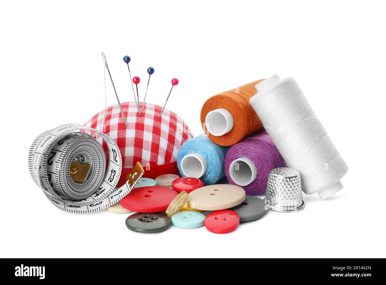 Spools of threads and sewing tools on white background Stock Photo - Alamy