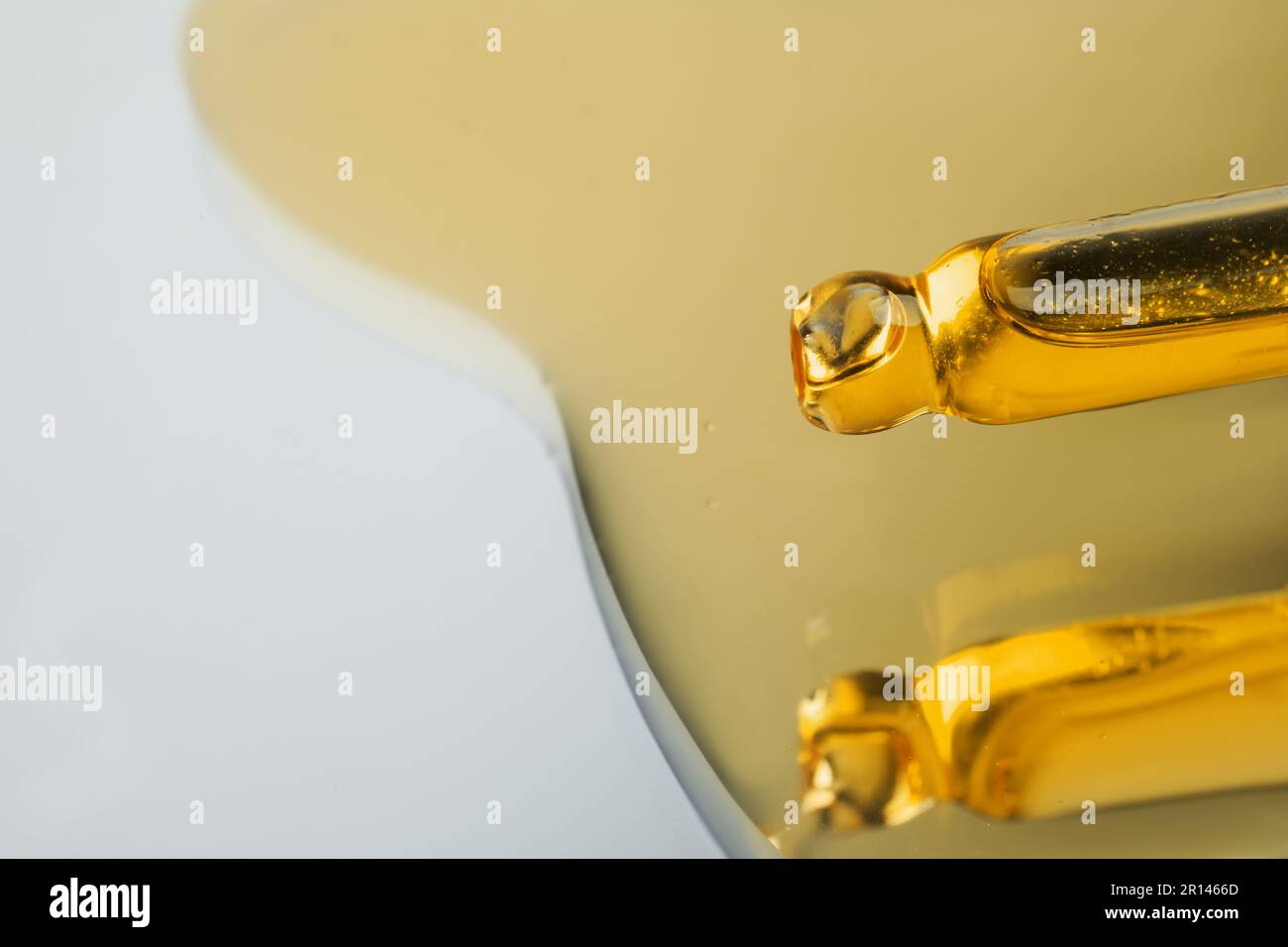 Yellow serum with pipette on mirror, closeup. Space for text Stock ...