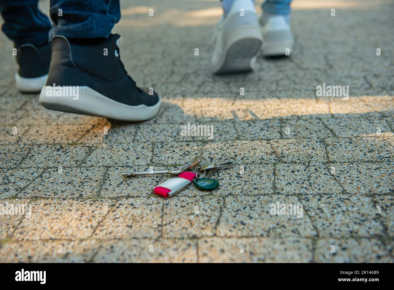 Men walking outside, focus on lost keys Stock Photo - Alamy