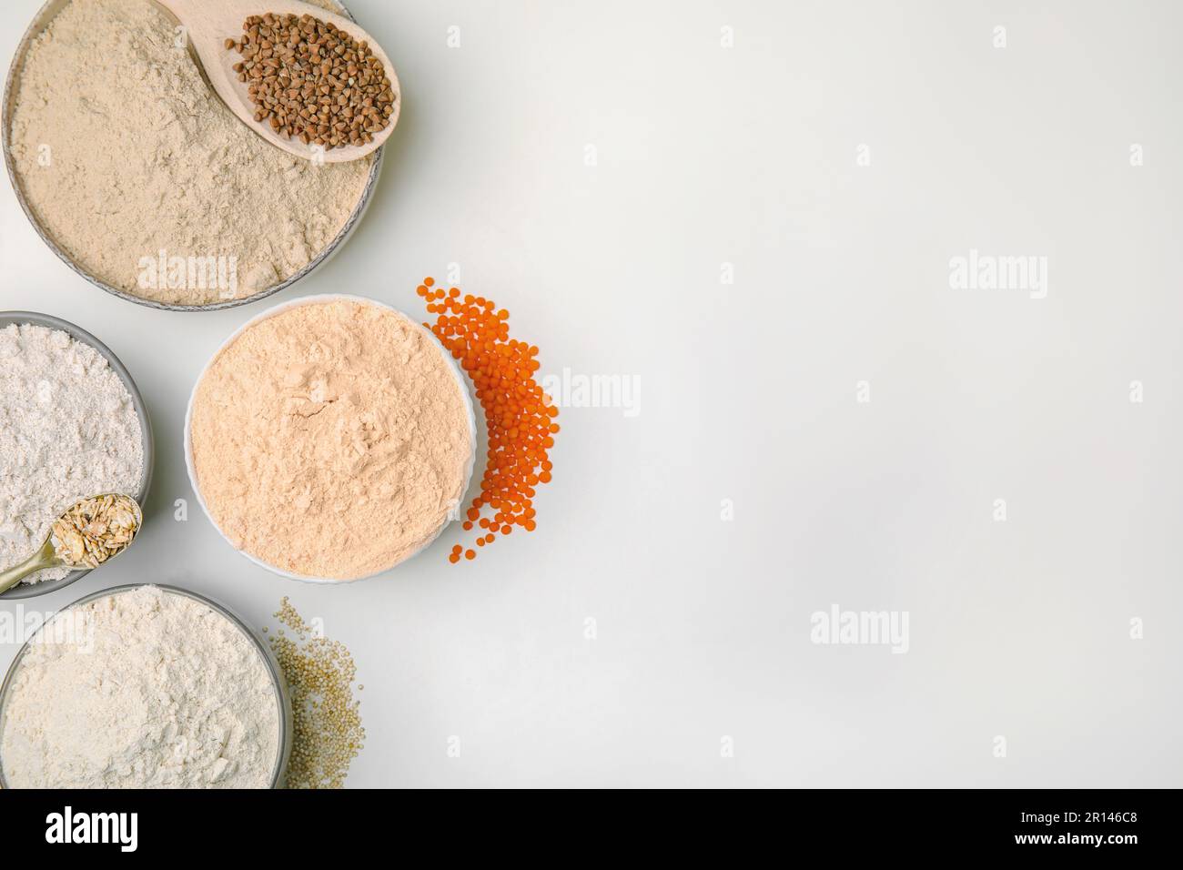 Different types of flour on white background, top view. Space for text ...