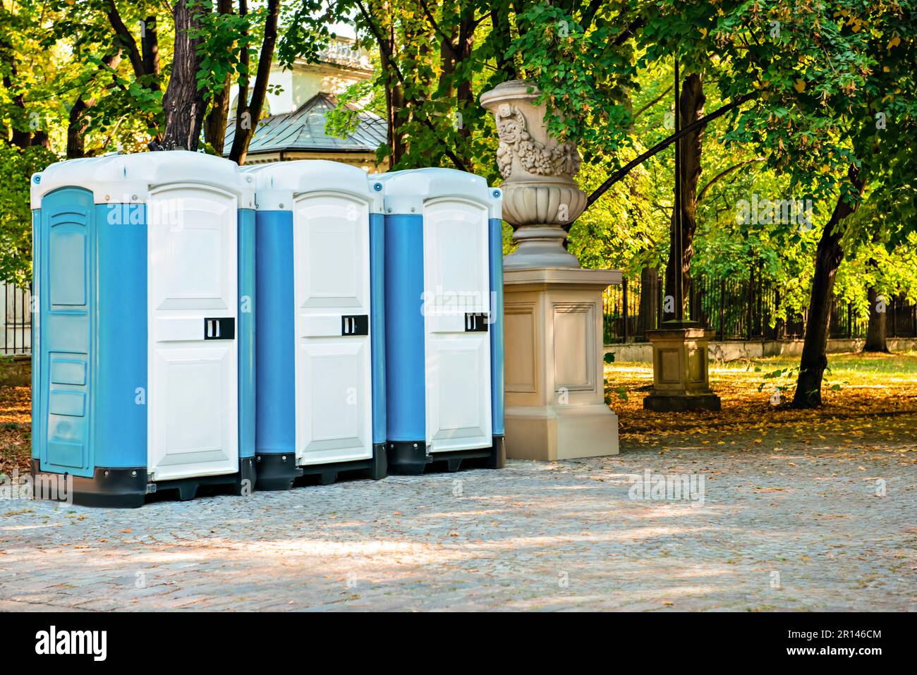 Public toilet cabins on street near trees Stock Photo - Alamy