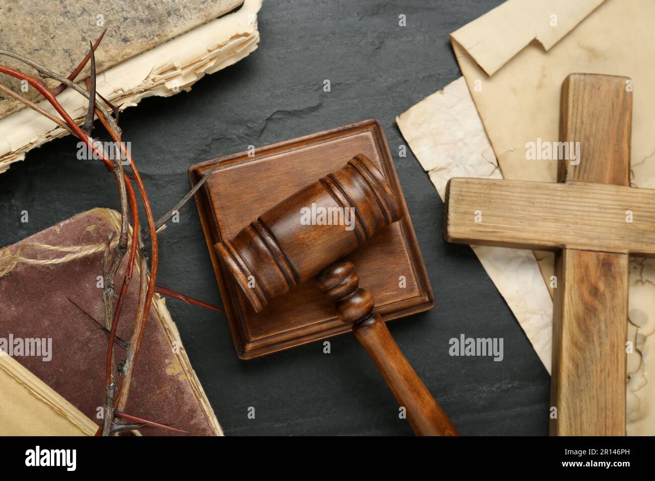 Judge gavel, wooden cross and crown of thorns on black table, flat lay ...