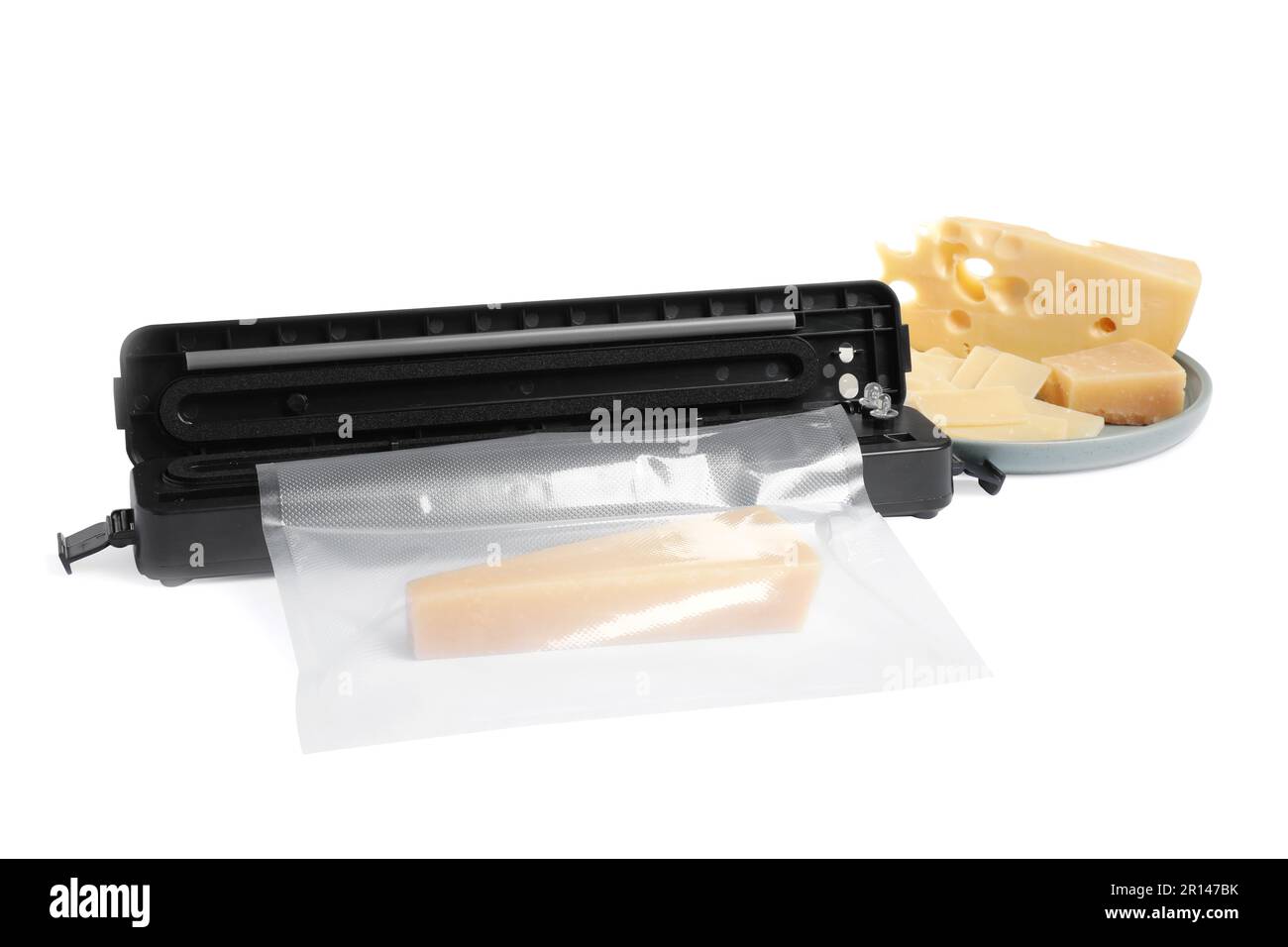 Vacuum packing sealer and plastic bag with cheese on white background ...