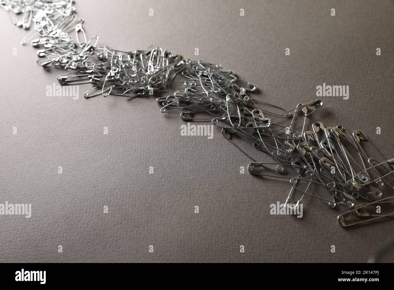 Grey safety pins hi-res stock photography and images - Alamy