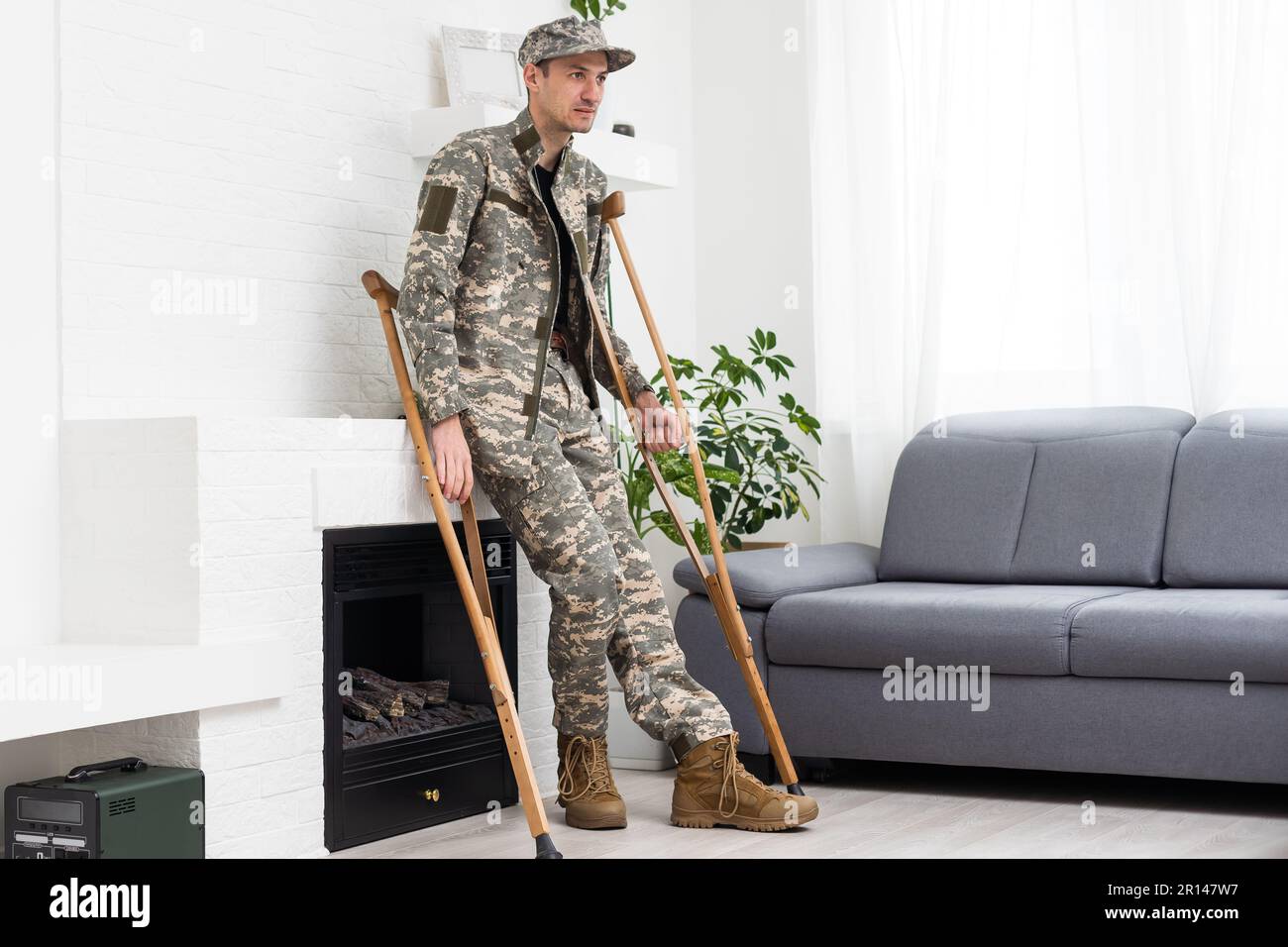 military man with crutches, disability Stock Photo - Alamy