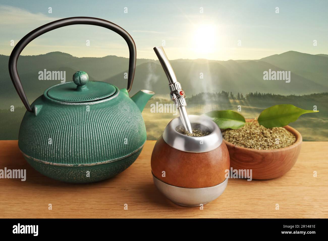 Calabash with mate tea, bombilla and teapot on wooden table and ...