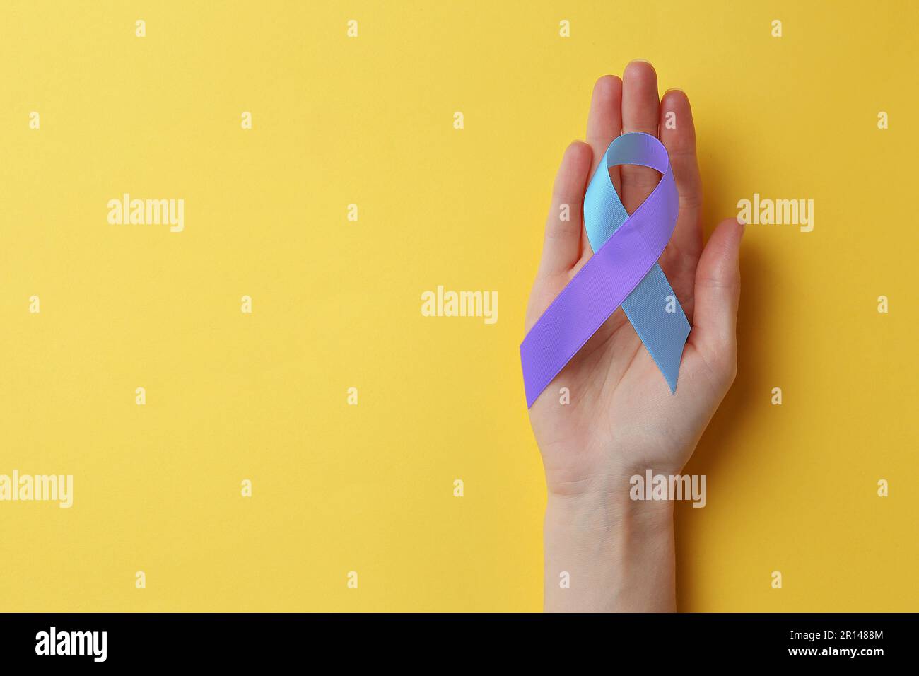 World Arthritis Day. Woman with blue and purple awareness ribbon on ...