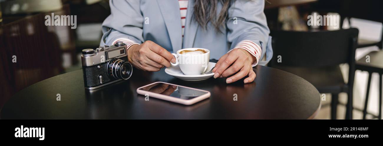 Modern lady sitting with coffee at coffee shop Stock Photo - Alamy
