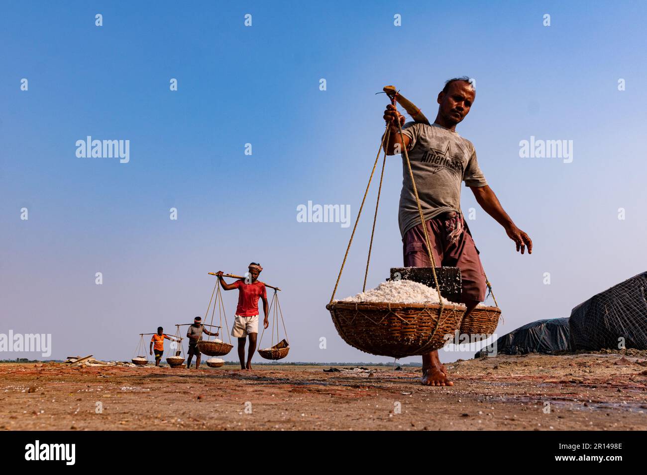 Salt workers are busy in making salt as the season has been started. In ...