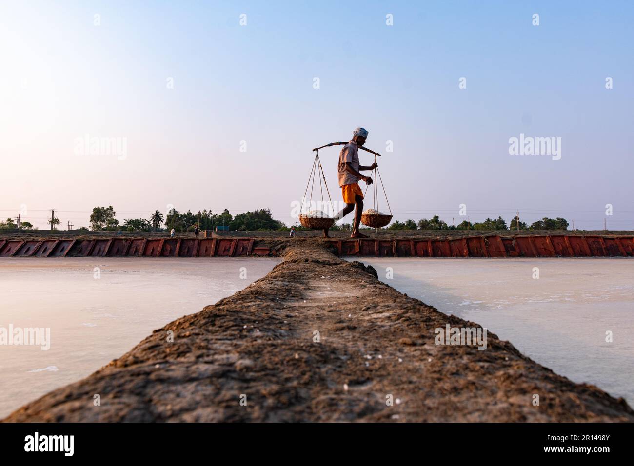 Salt workers are busy in making salt as the season has been started. In ...