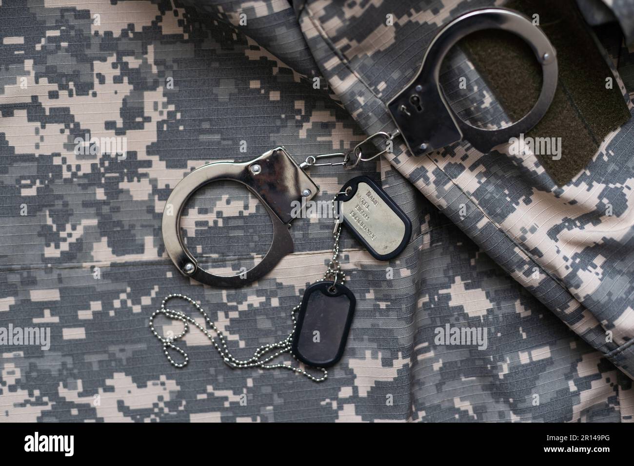 A military camouflage, handcuffed. Concept: war criminal, prisoner of ...
