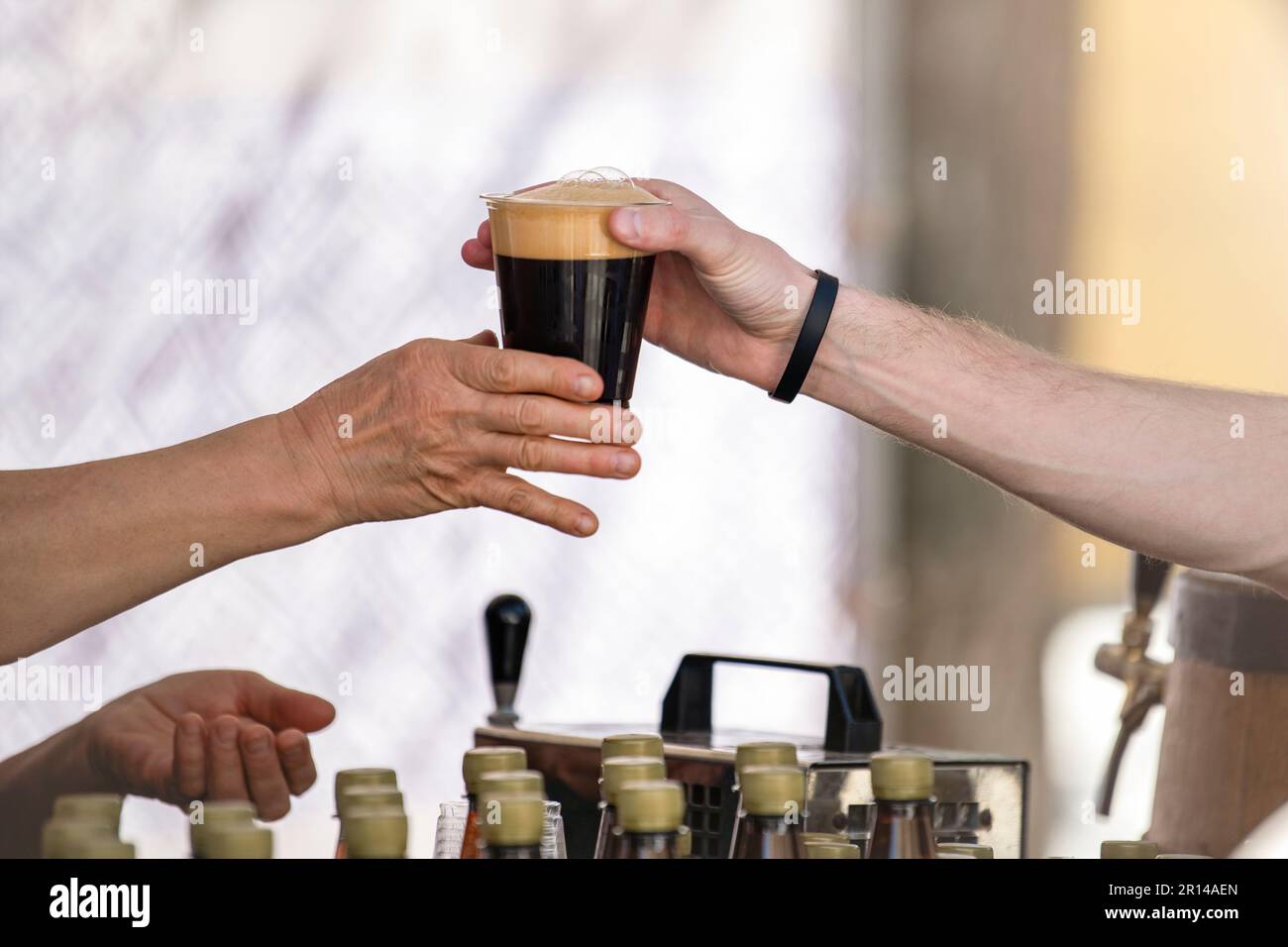 The bartender gives a glass of beer to the customer. The concept of the ...