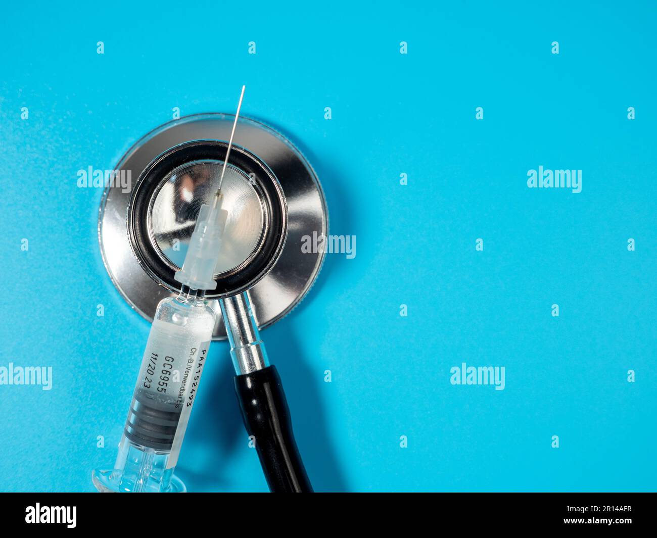 Injection vaccine on a blue background, medicine concept. On the ...