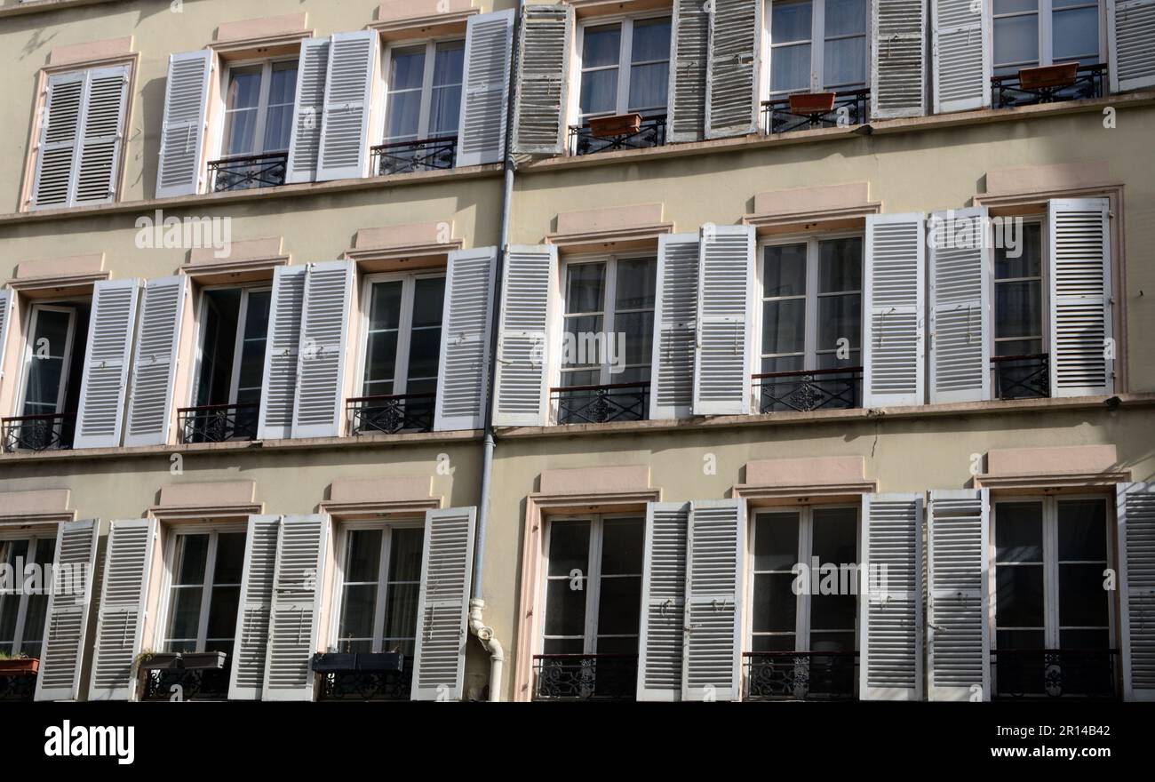 White wooden shutter balconies on building in Paris, France Stock Photo ...