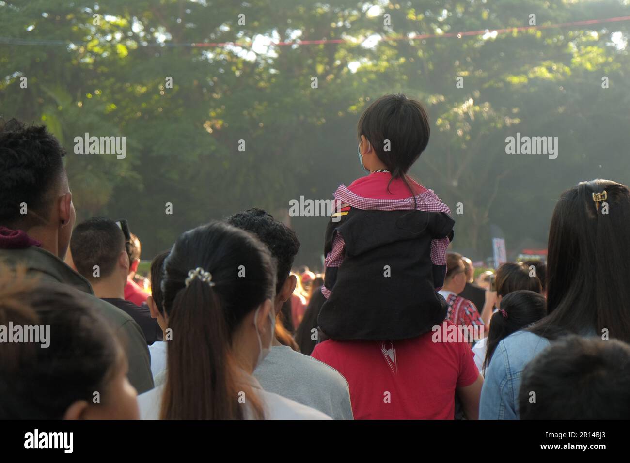Malaybalay, Philippines - father carries his son, a young boy with a ...