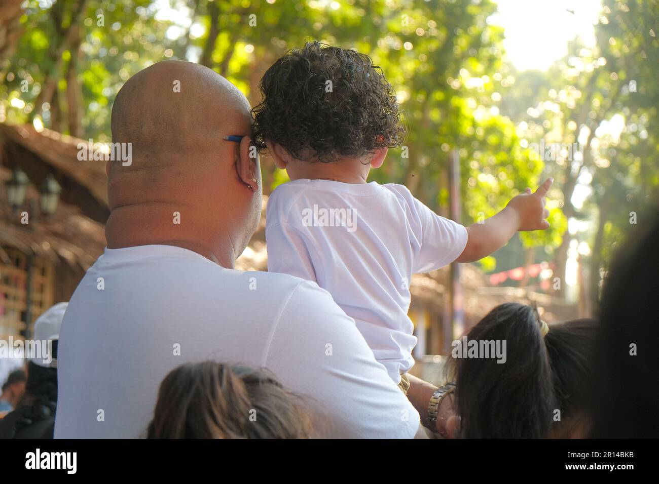 Malaybalay, Philippines - bald father carries son, a young boy with ...