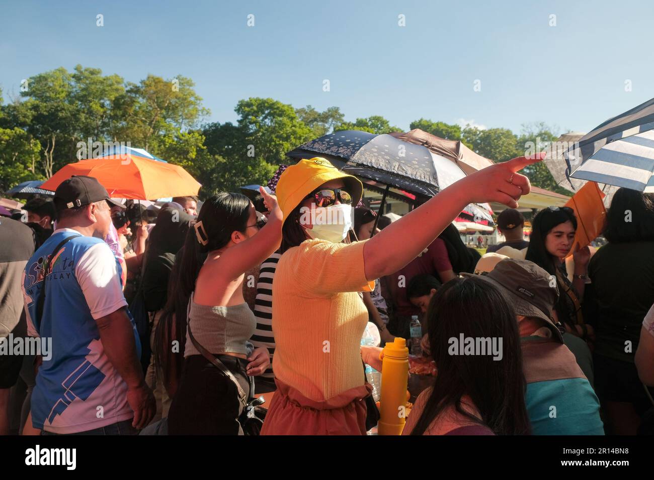 Malaybalay, Philippines - woman covered in bucket hat, shades, and face ...