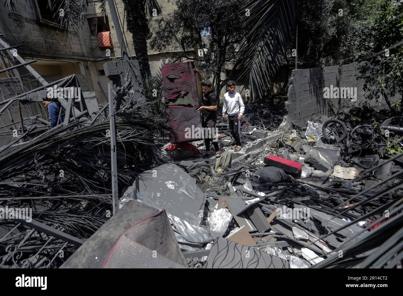 Gaza, Palestine. 11th May, 2023. Palestinians inspect the rubble of a ...