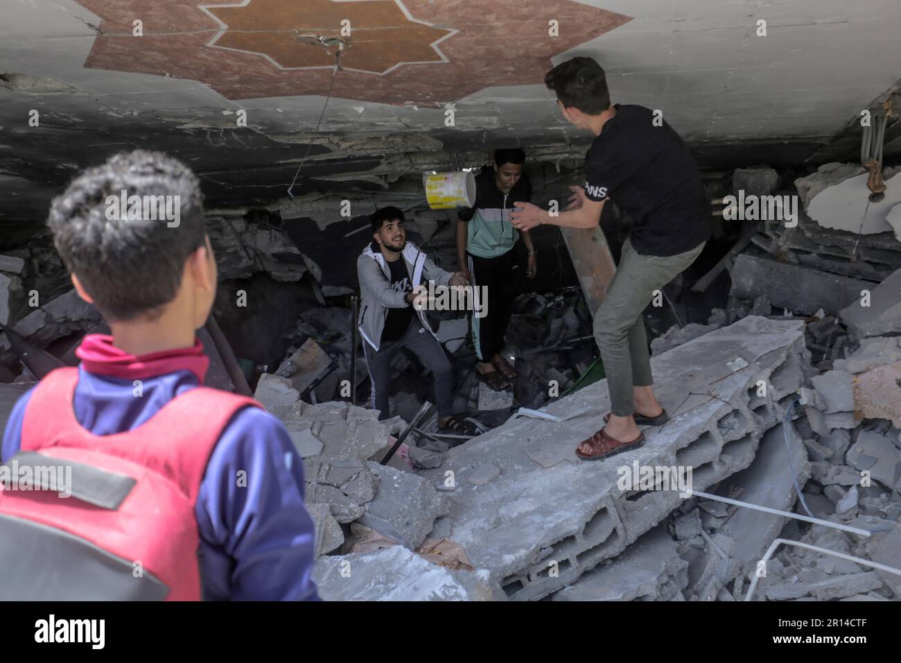 Gaza, Palestine. 11th May, 2023. Palestinians inspect the rubble of a ...