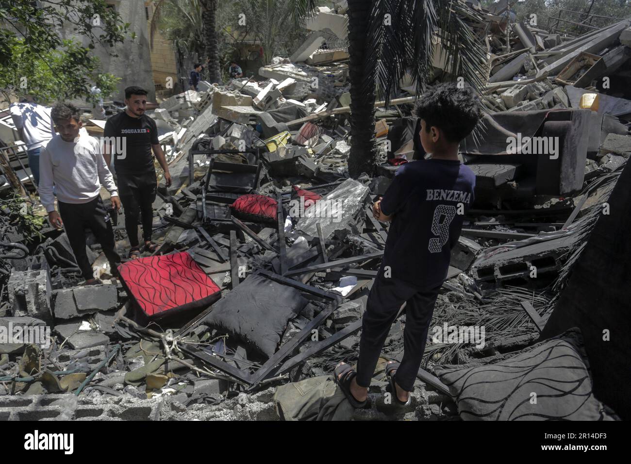Gaza, Palestine. 11th May, 2023. Palestinians inspect the rubble of a ...