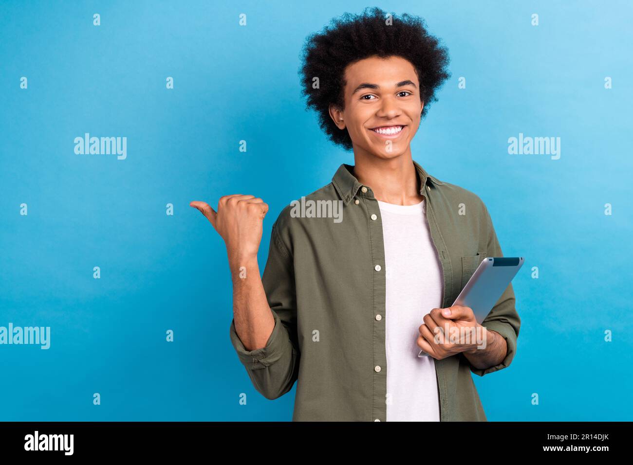 Photo of young student guy hold new device tablet pointing finger empty ...
