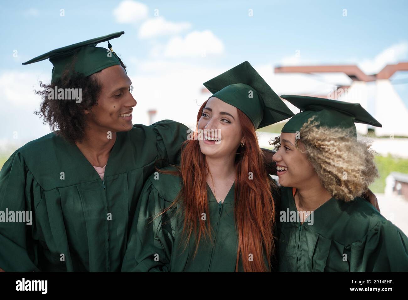 Three recently graduated students celebrating their university degree ...