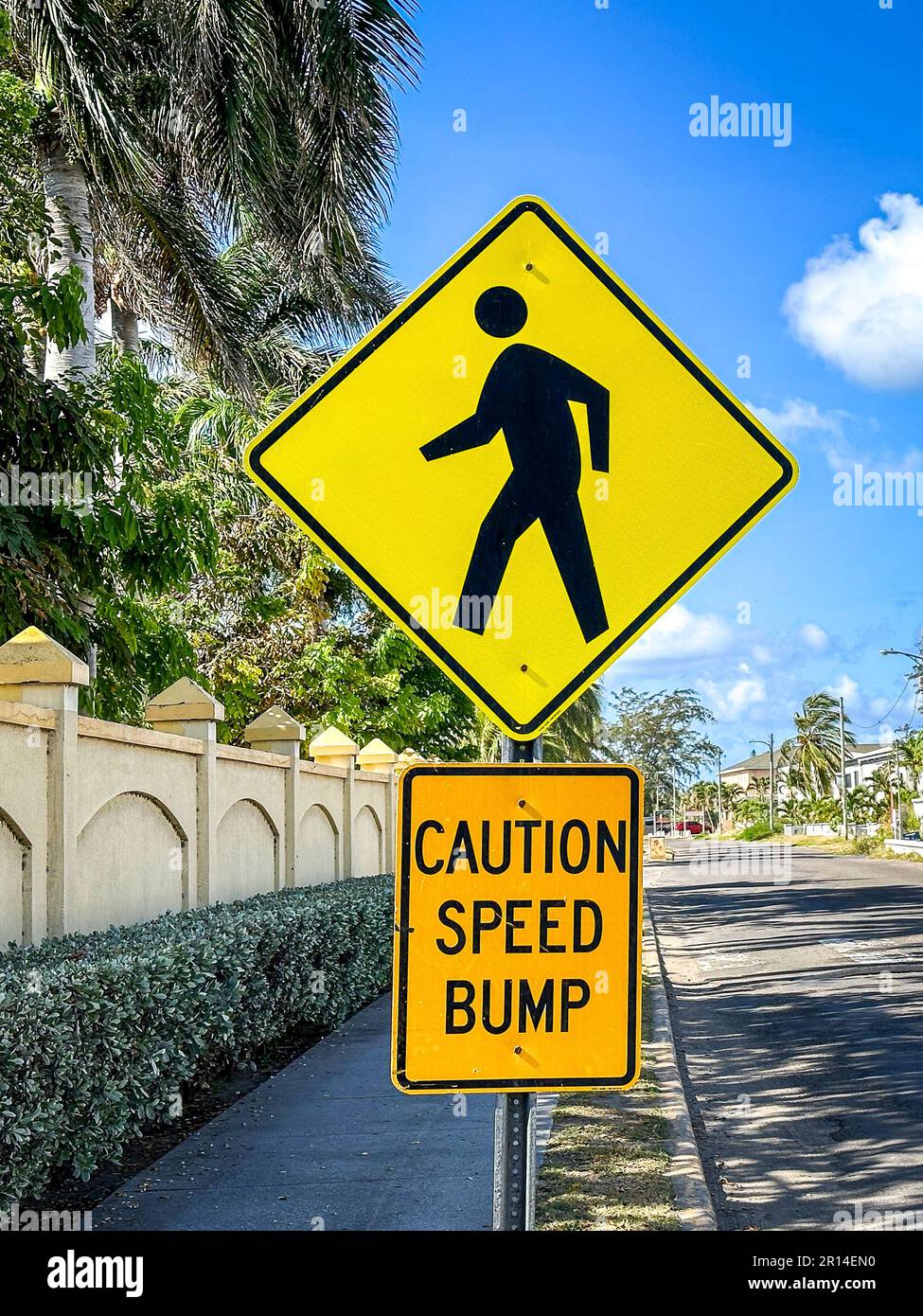 Pedestrian and caution speed bump sign Stock Photo - Alamy
