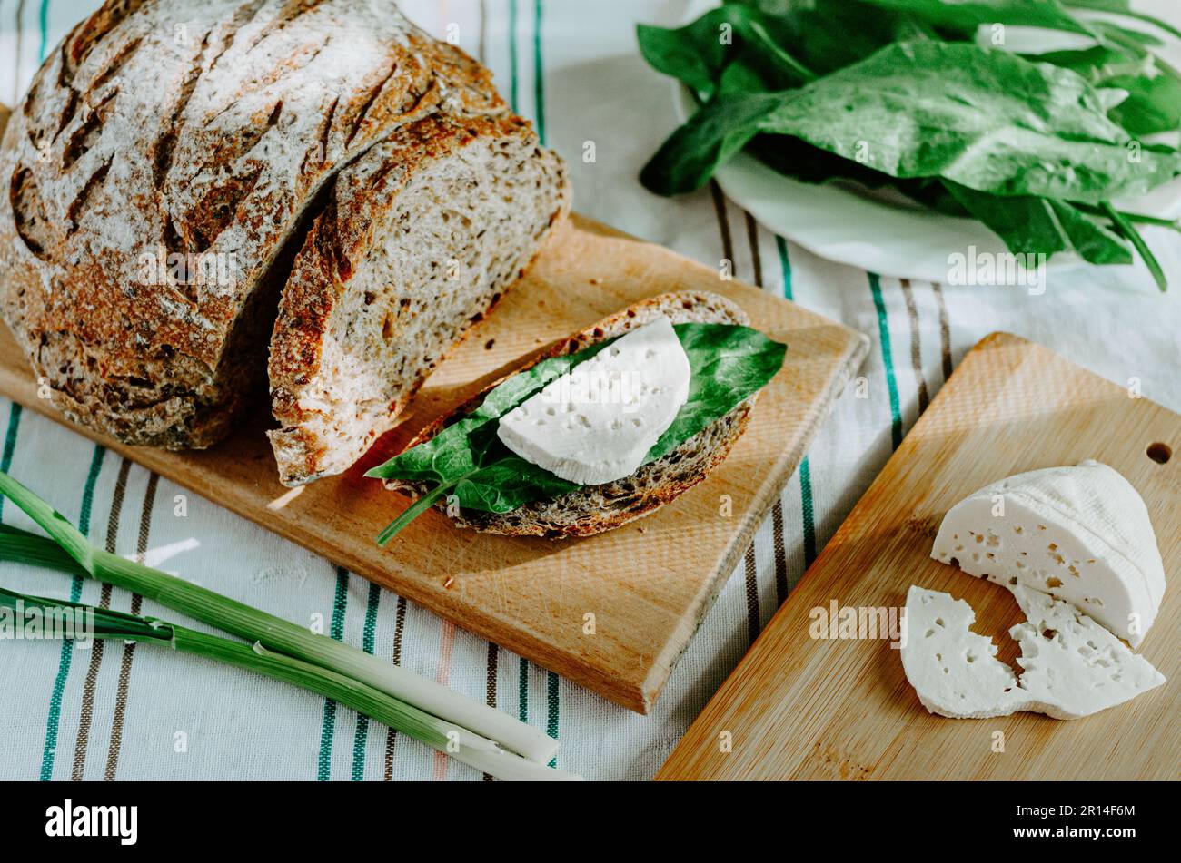 Rustic food layout: sourdough bread with cottage cheese and greens ...