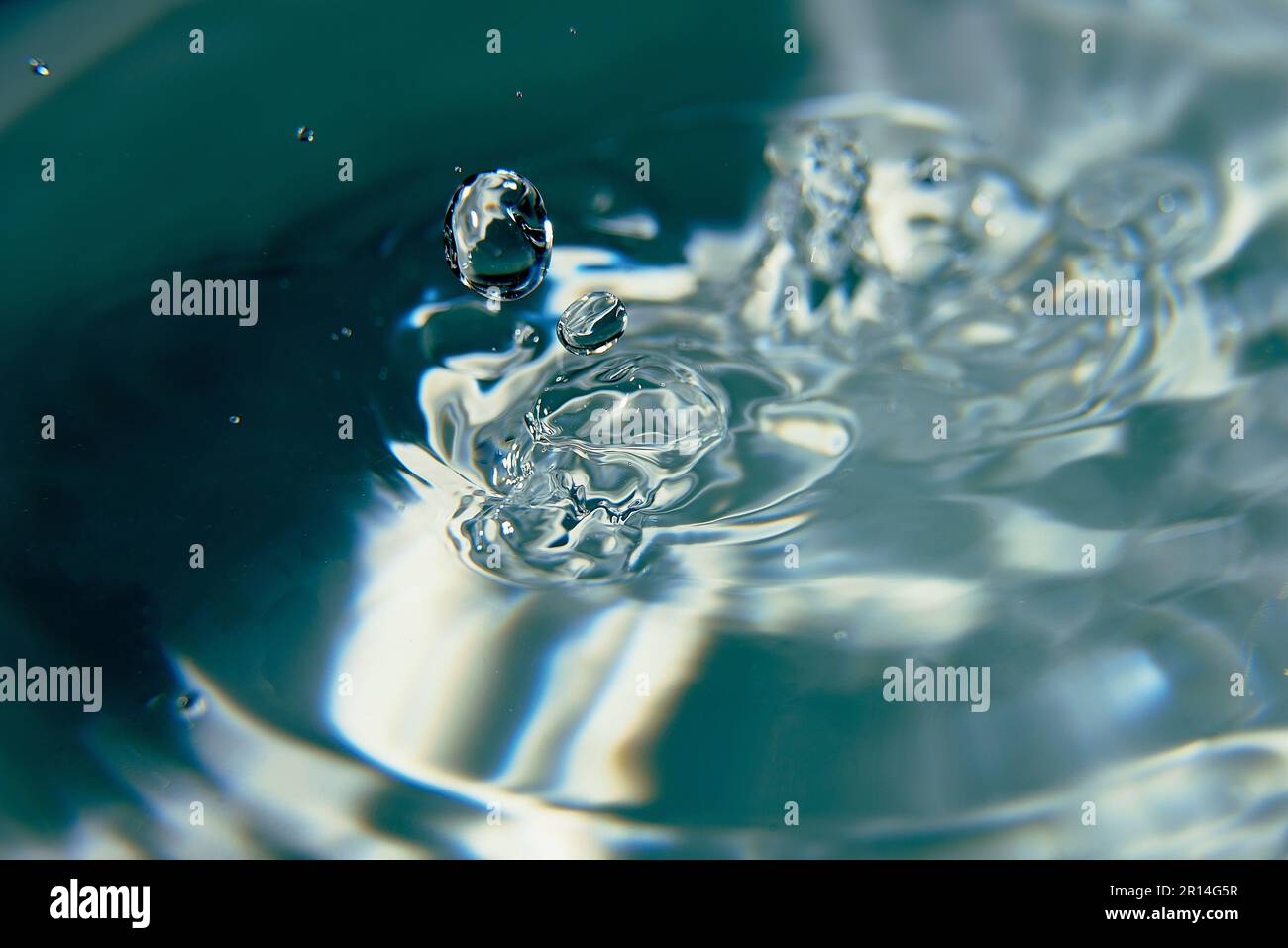 040.One or more drops of water splashing into waves and undefined ...