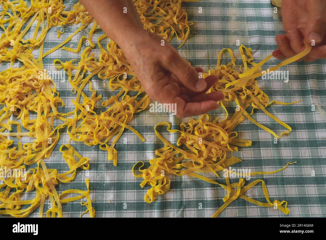 Selective focus on pasta, homemade Italian pasta, hands of a person ...