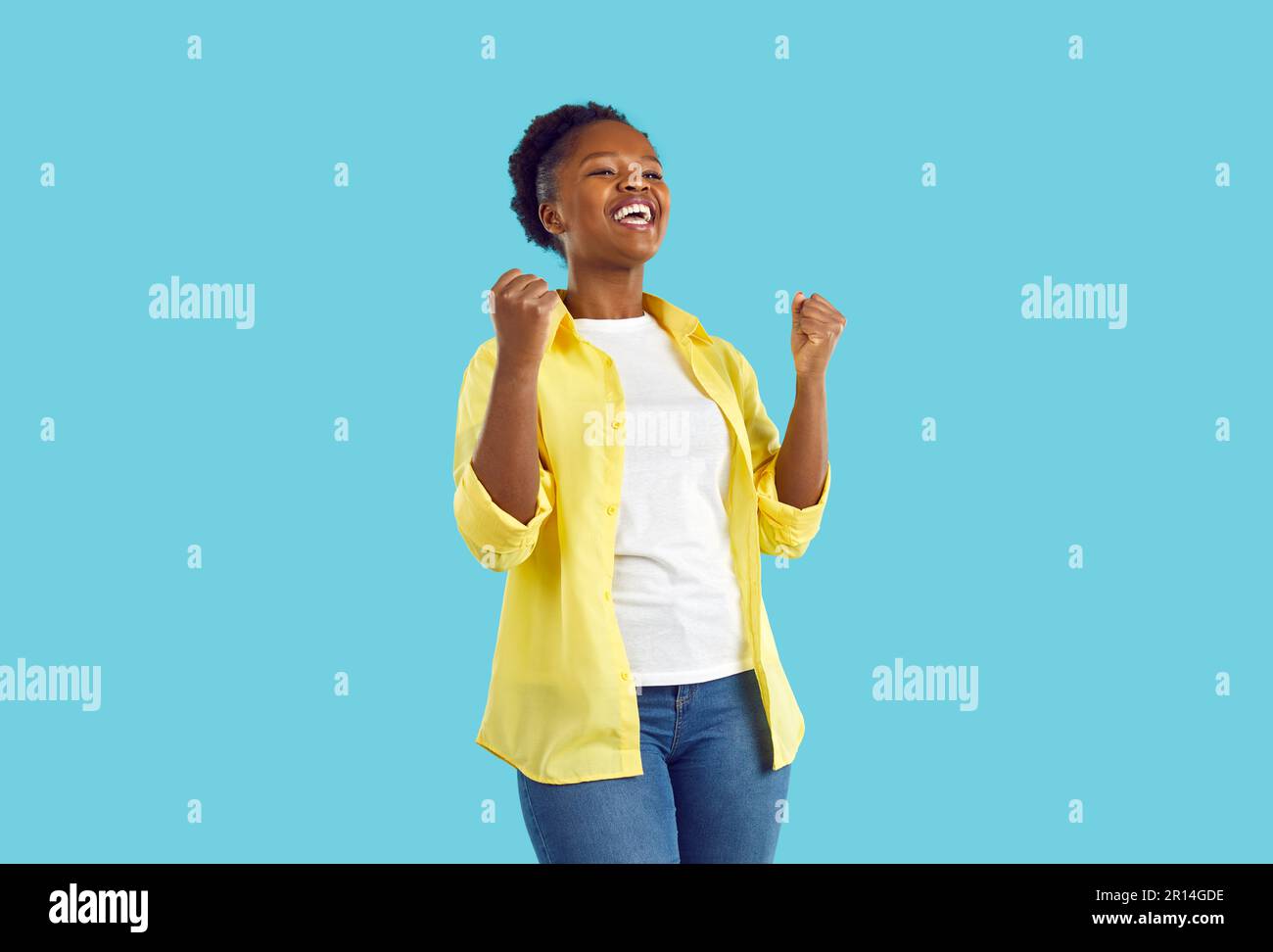 Happy, excited young woman celebrating success and having fun isolated ...