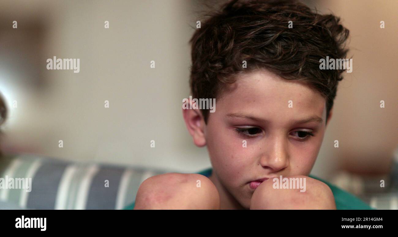 Thoughtful child boy face on couch at night. Pensive kid thinking Stock ...