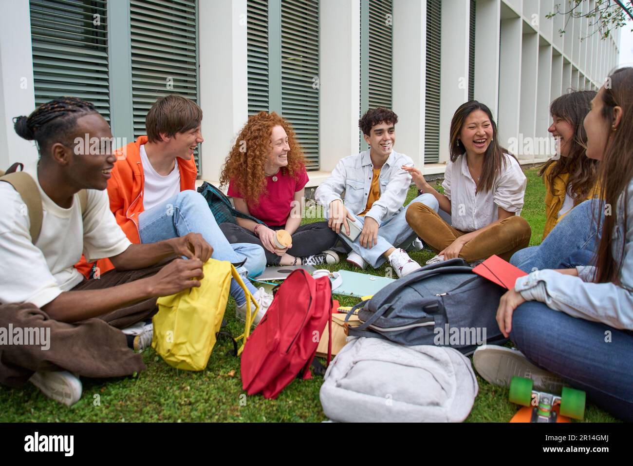 Group cheerful students gathered together outdoors. Multiracial college ...