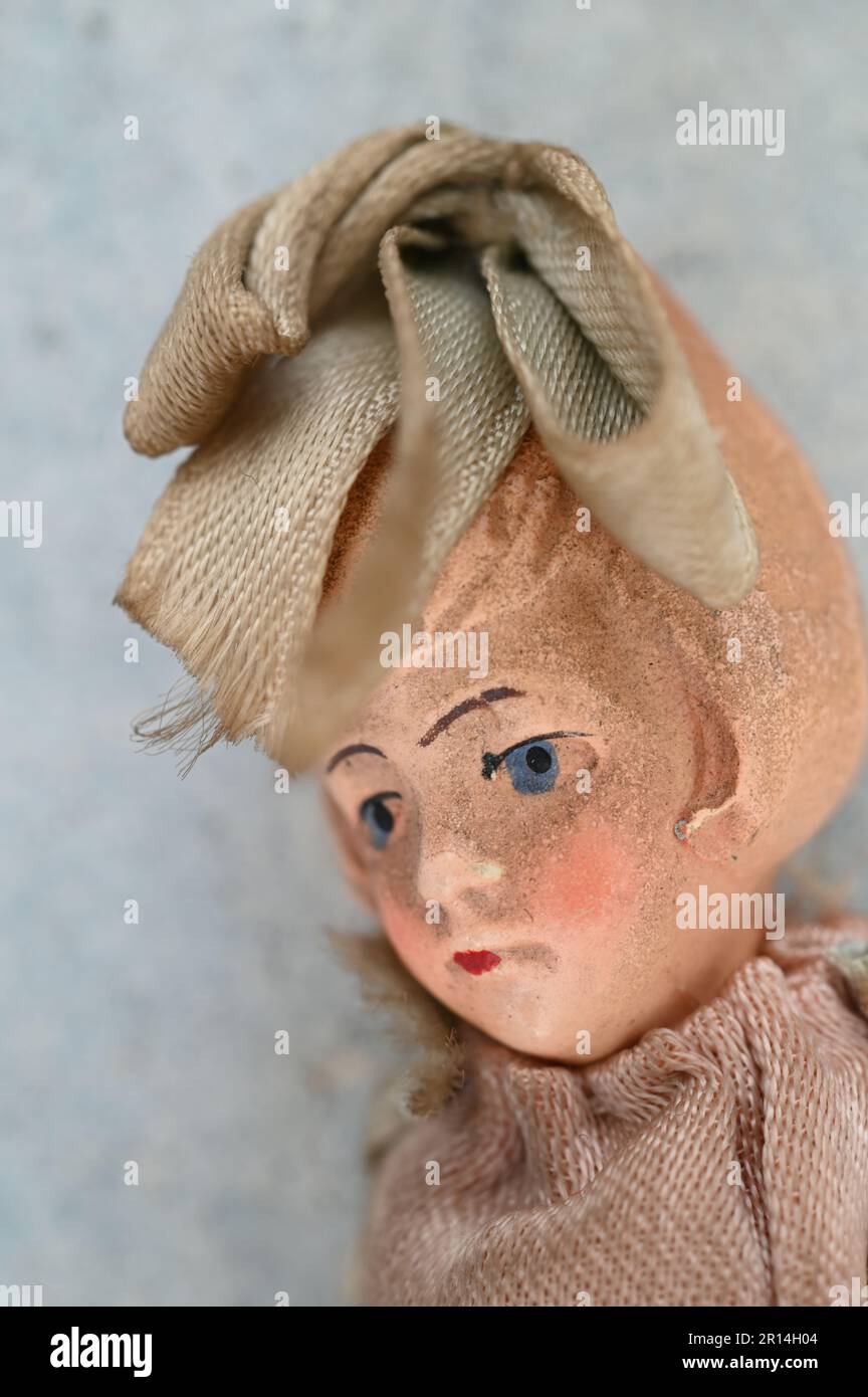 Head and shoulders of 1910s girl doll with large bow in her hair and ...