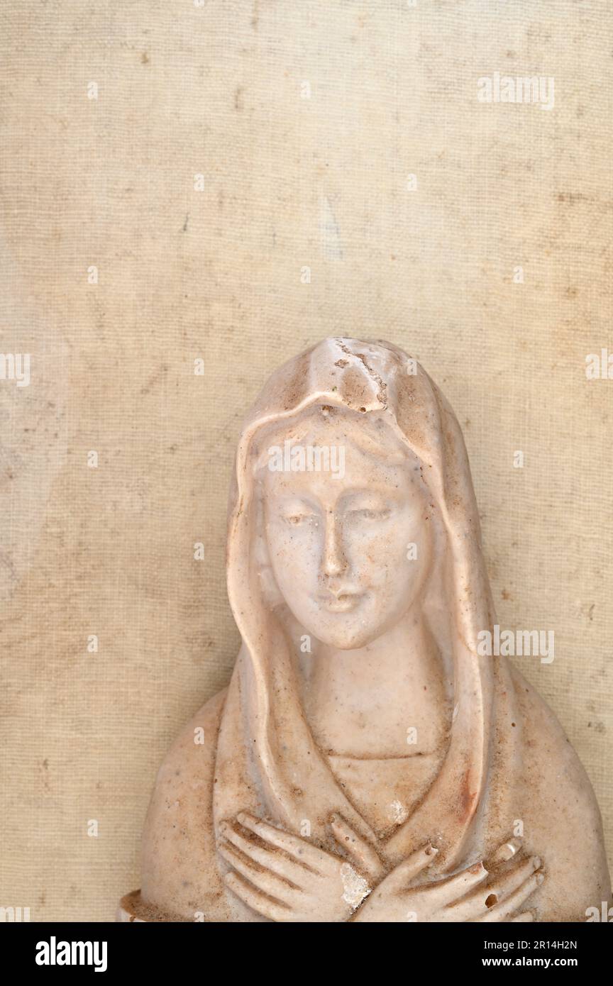 Cast model of serene woman with head covering and eyes lowered in ...