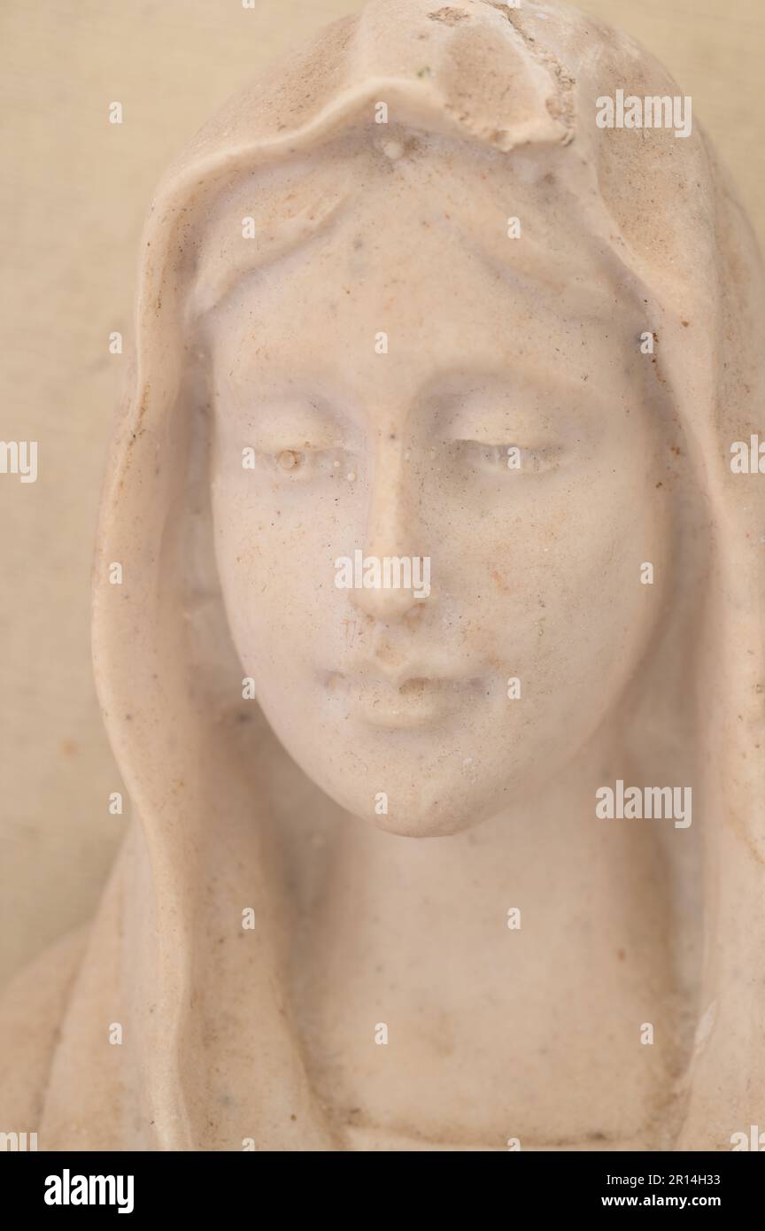 Cast model of serene woman with head covering and eyes lwoered in ...