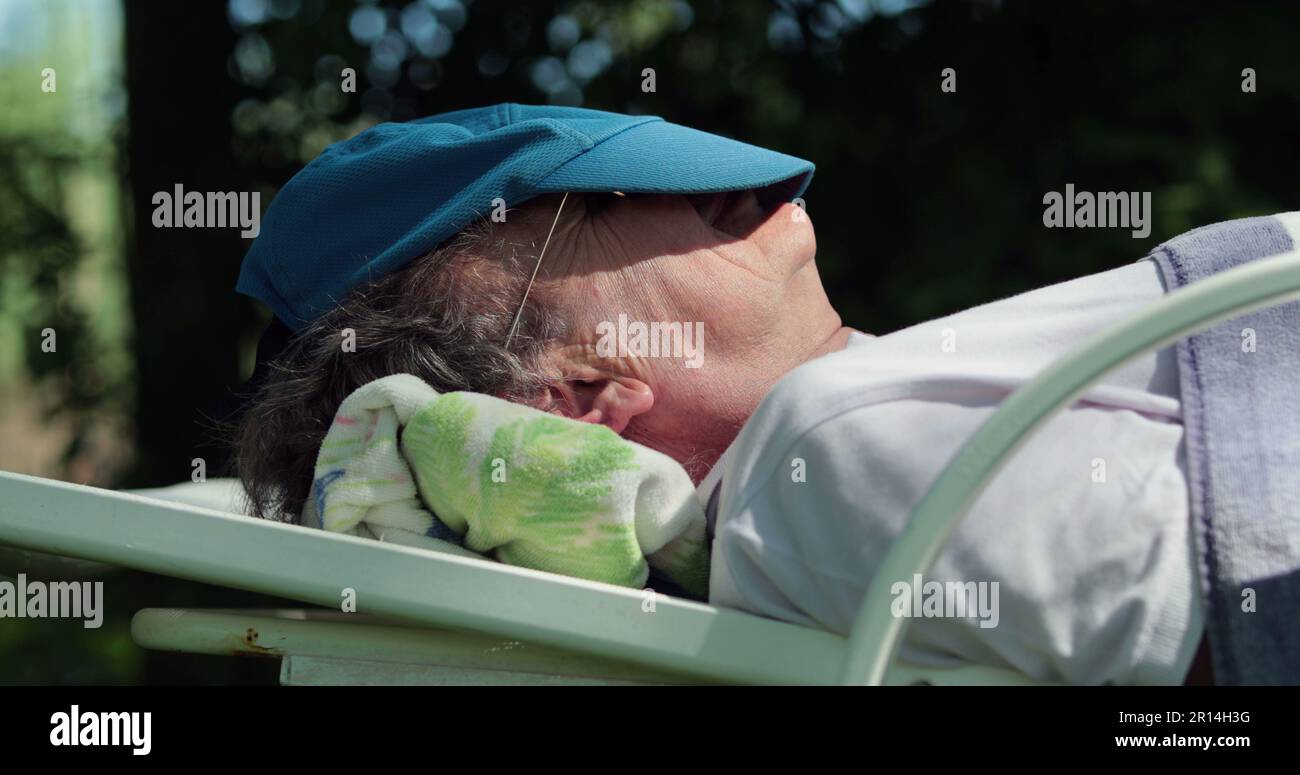 Senior retired person resting with had covering face Stock Photo - Alamy