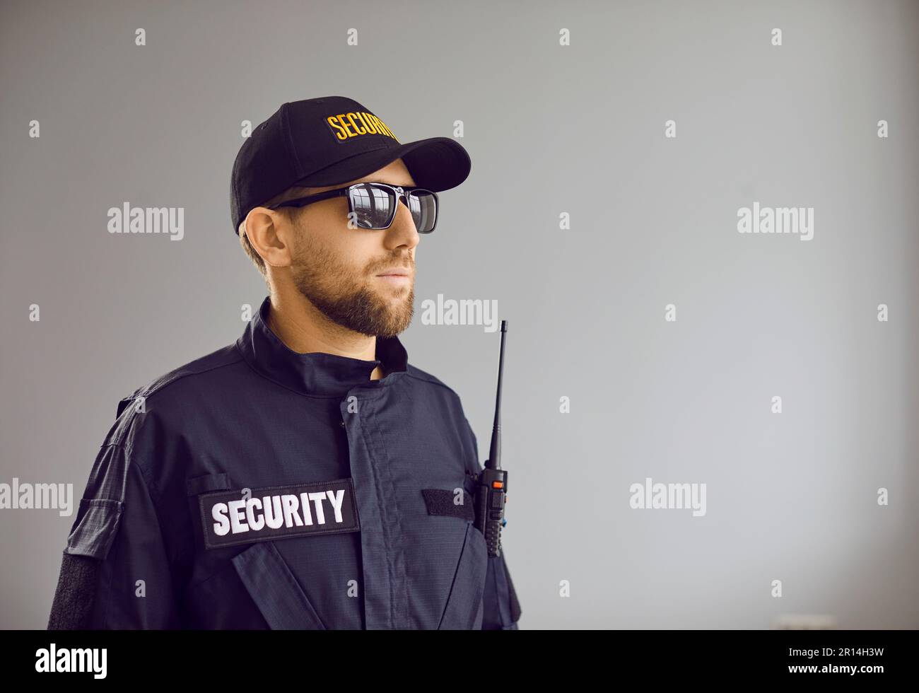 Portrait of male security guard man standing in uniform and sunglasses ...