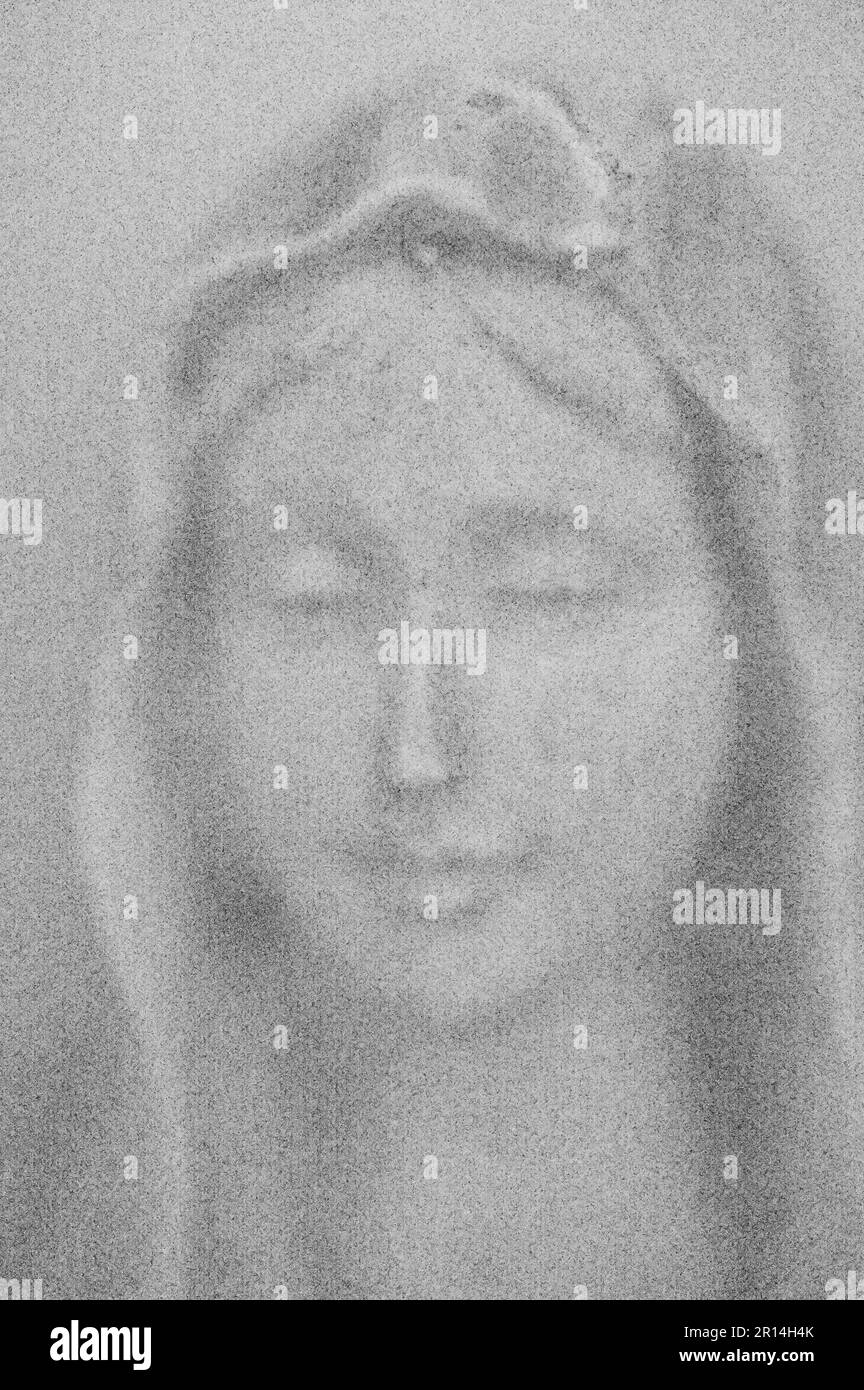 Cast model of serene woman with head covering and eyes lwoered in ...