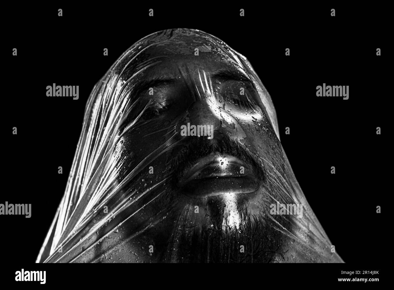 Man with plastic bag over his head, suffocated. Black and white shot ...