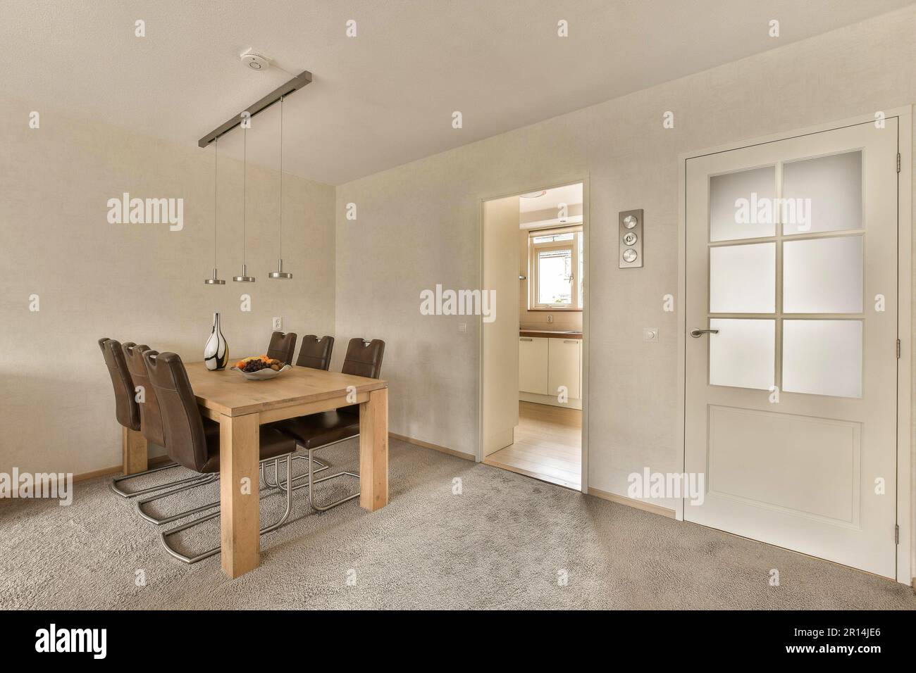 a dining room with a table and chairs on the floor in front of an open ...